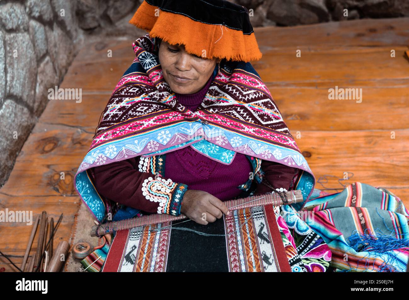 A Peruvian Woman Weaves Textiles on a Loom using Traditional Techniques ...
