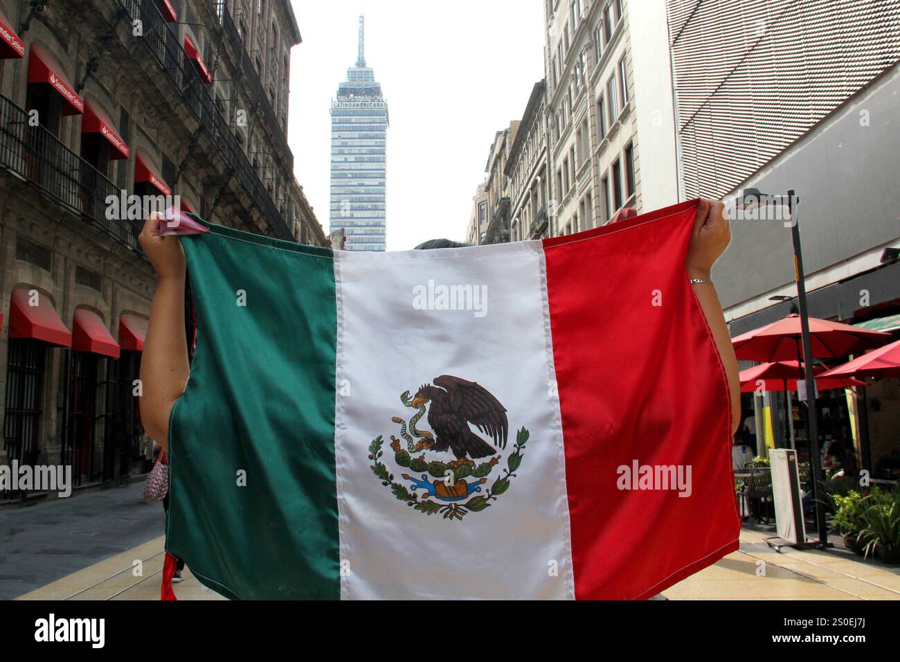 Mexico City, Mexico - Sep 6 2023: Woman proudly raises the Mexican flag ...