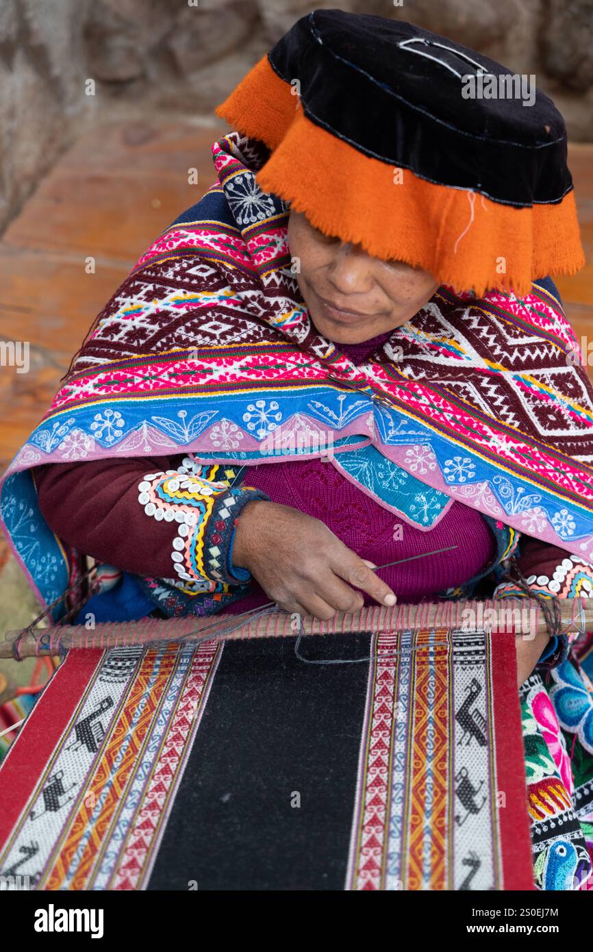A Peruvian Woman Weaves Textiles on a Loom using Traditional Techniques ...