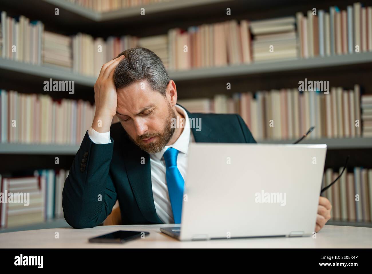 Headache and eye strain on laptop. Business man with stress and fatigue ...