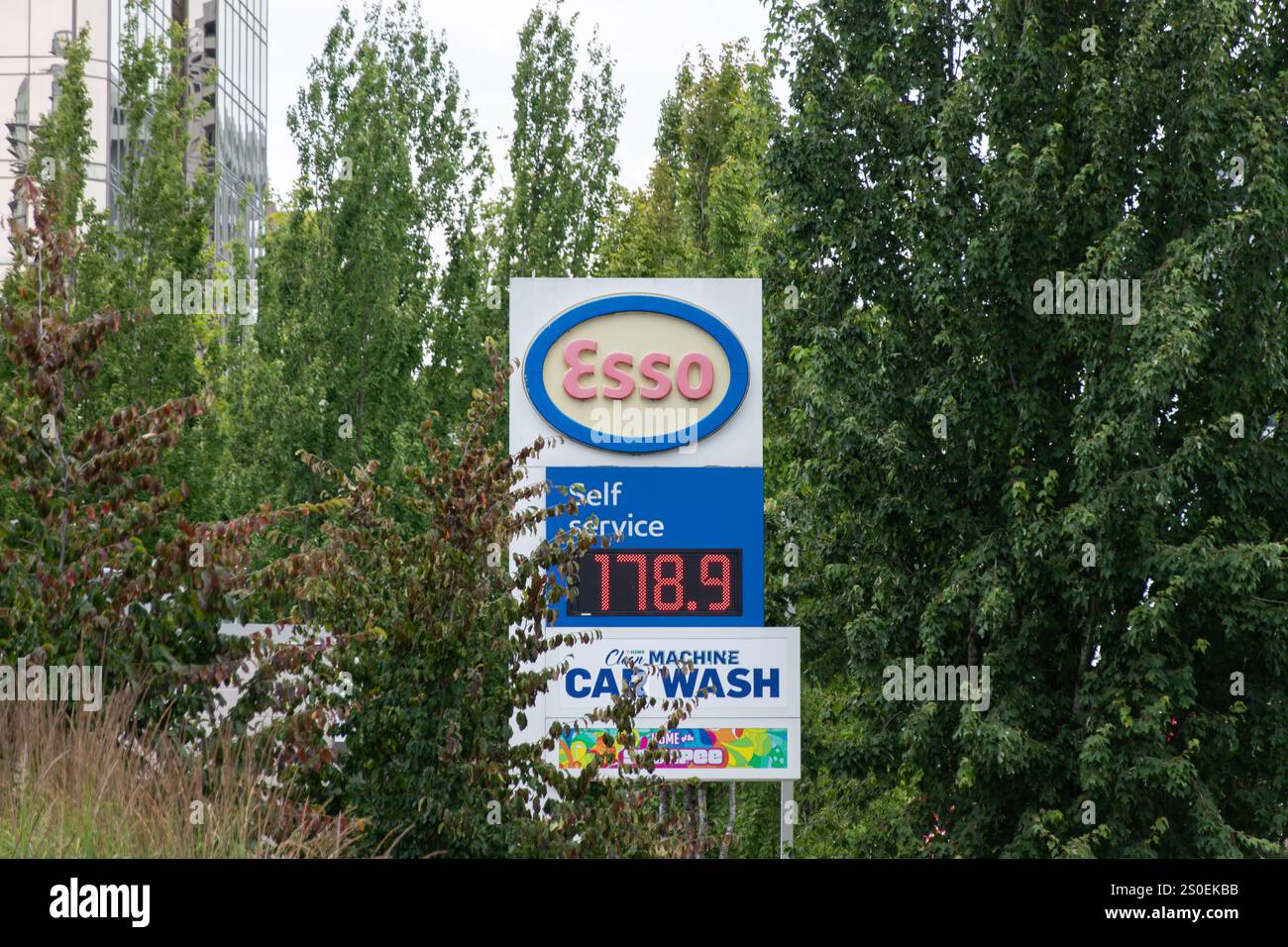Burnaby, CANADA - JUL 17 2024 : Fuel price sign at an Esso gas station showing self-service fuel ...