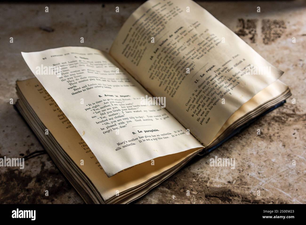 A book is open to a page with a poem on it. The book is old and the ...