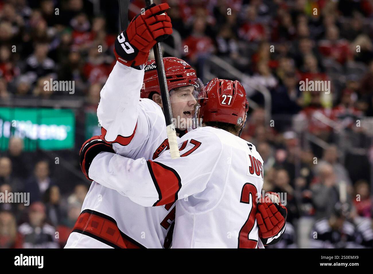 Carolina Hurricanes left wing Eric Robinson, left, is congratulated by ...