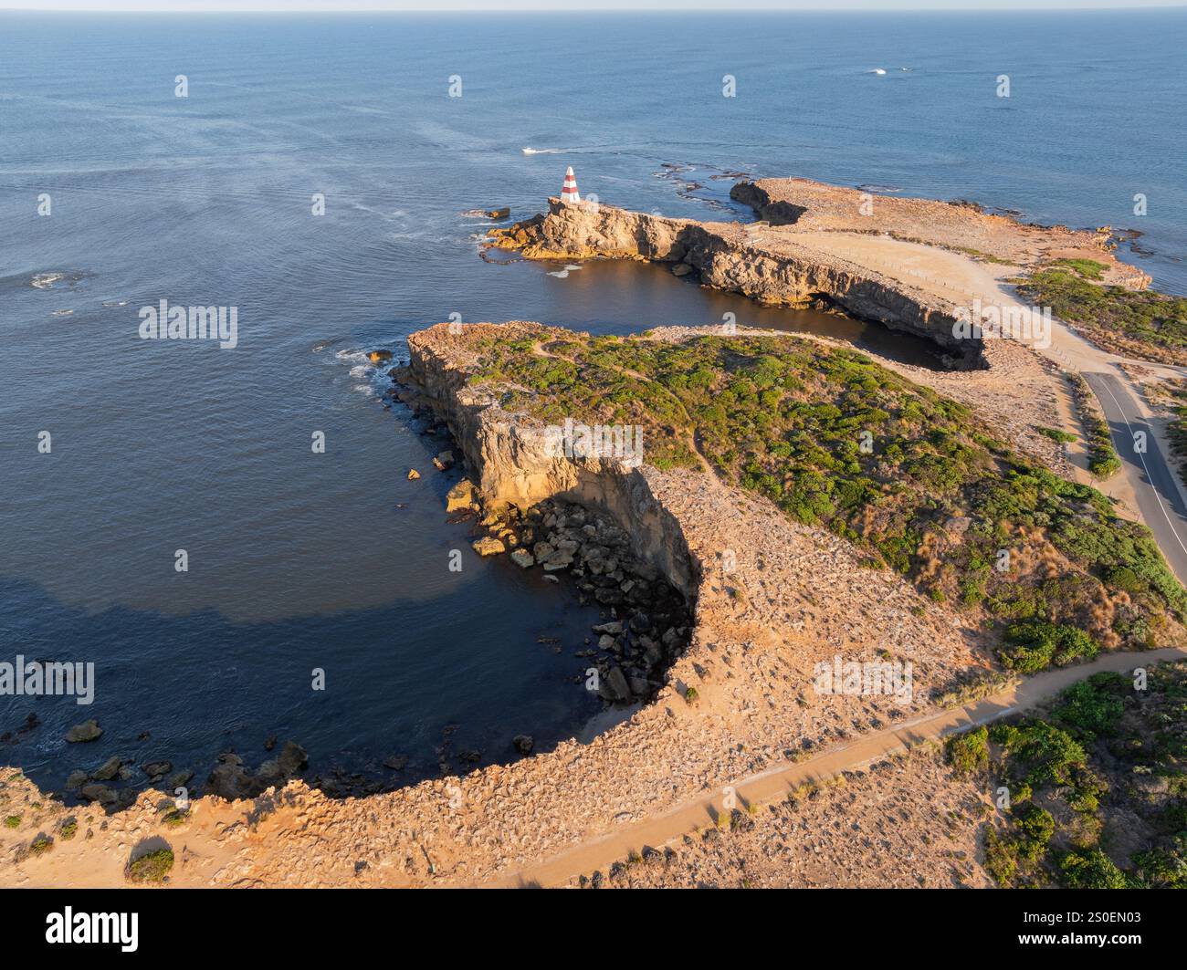 Aerial view of a beacon ona rocky point off a rugged coastline at Robe ...