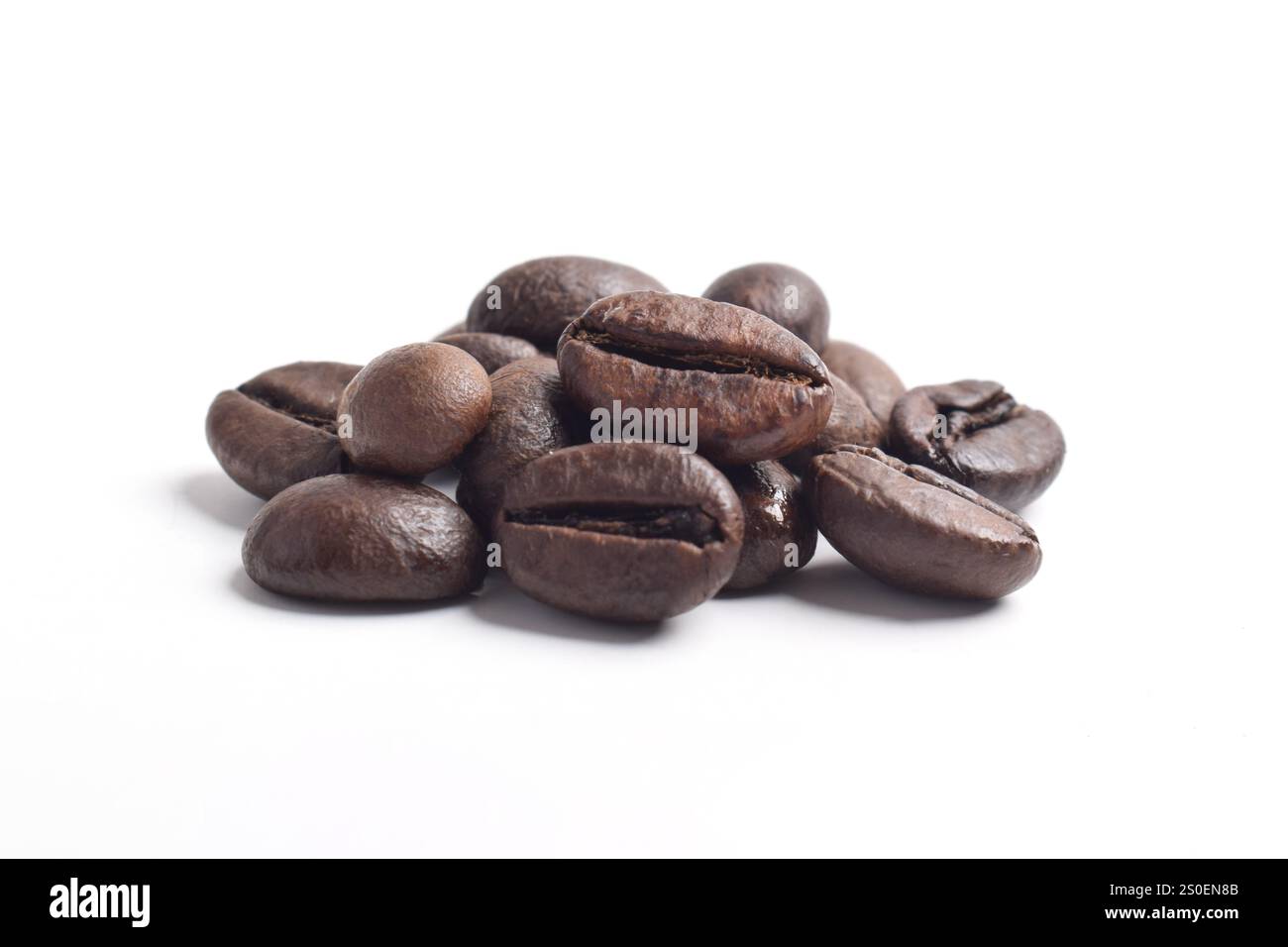 Stack of coffee beans isolated on white background Stock Photo - Alamy