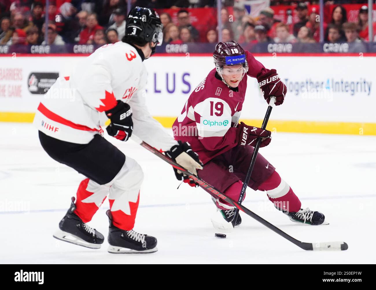 Ottawa, Canada. 27th Dec, 2024. Latvia's Bruno Osmanis (19) tries to ...