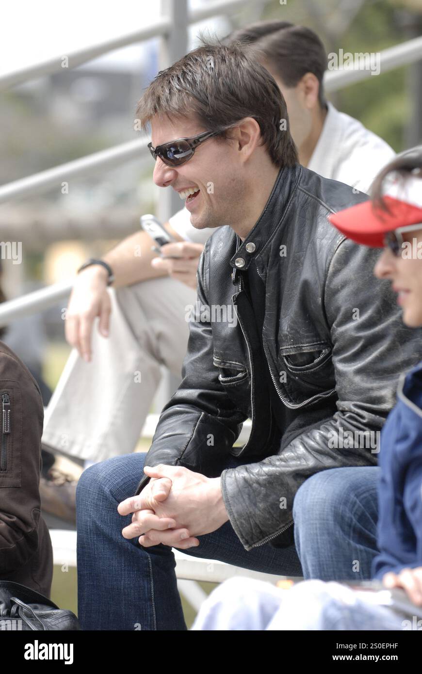 Tom Cruise attends a public event, sporting a black leather jacket and ...