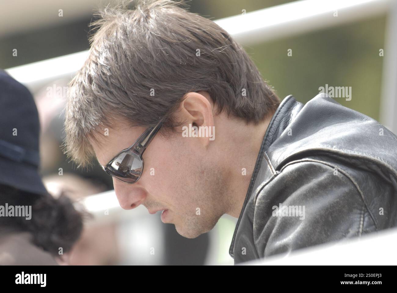 Tom Cruise attends a public event, sporting a black leather jacket and ...