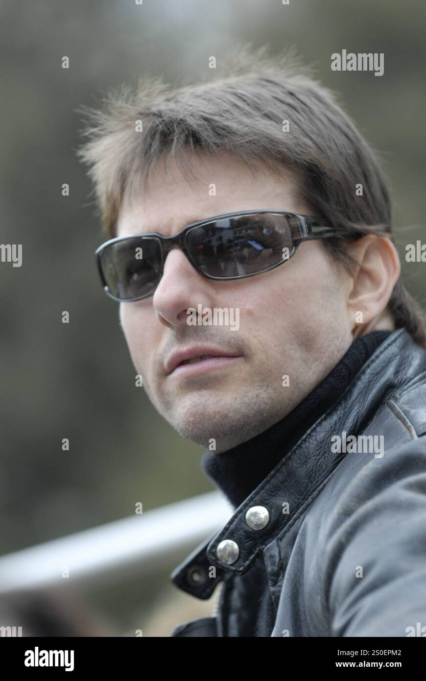Tom Cruise attends a public event, sporting a black leather jacket and ...