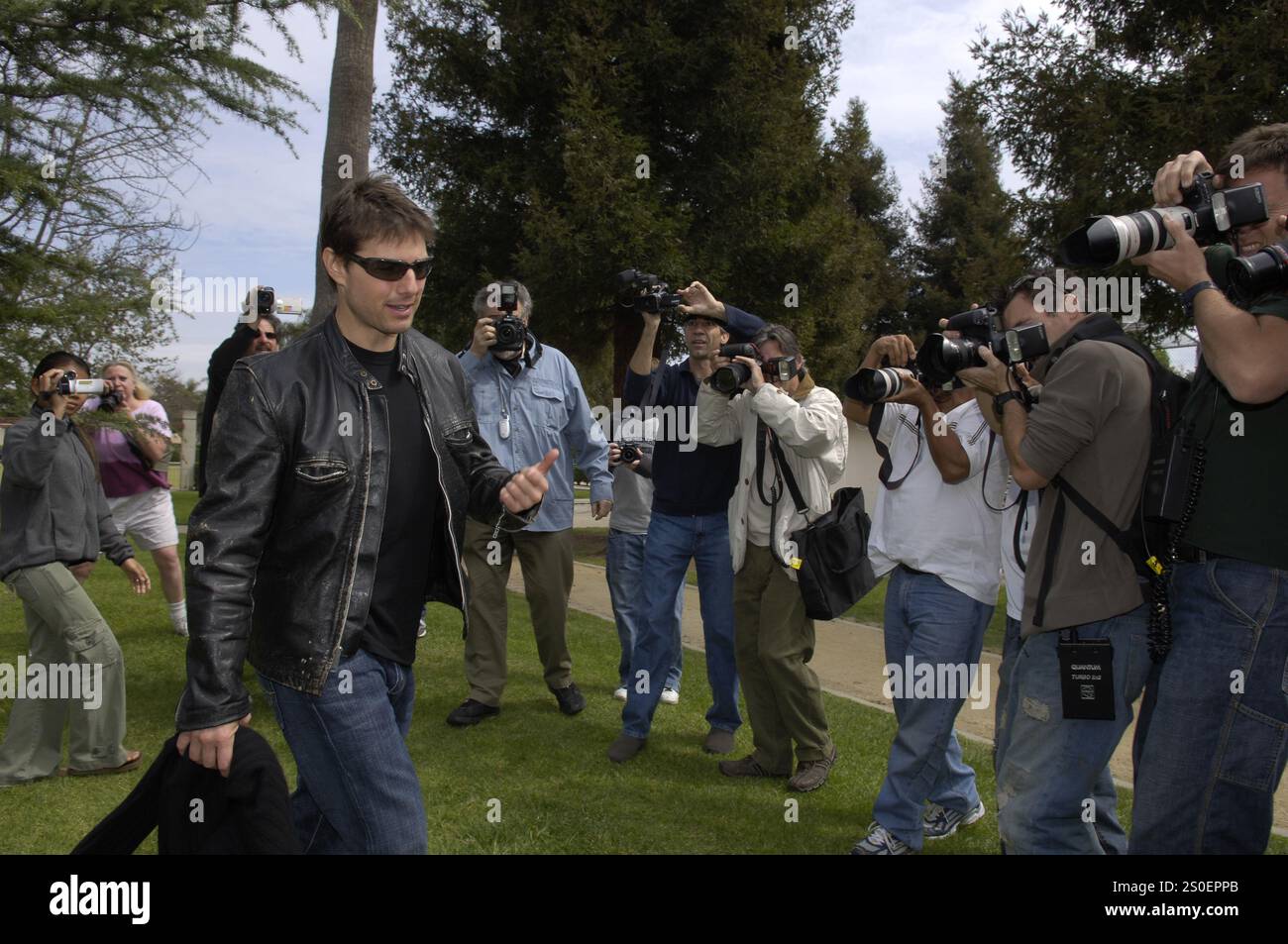 Tom Cruise attends a public event, sporting a black leather jacket and ...