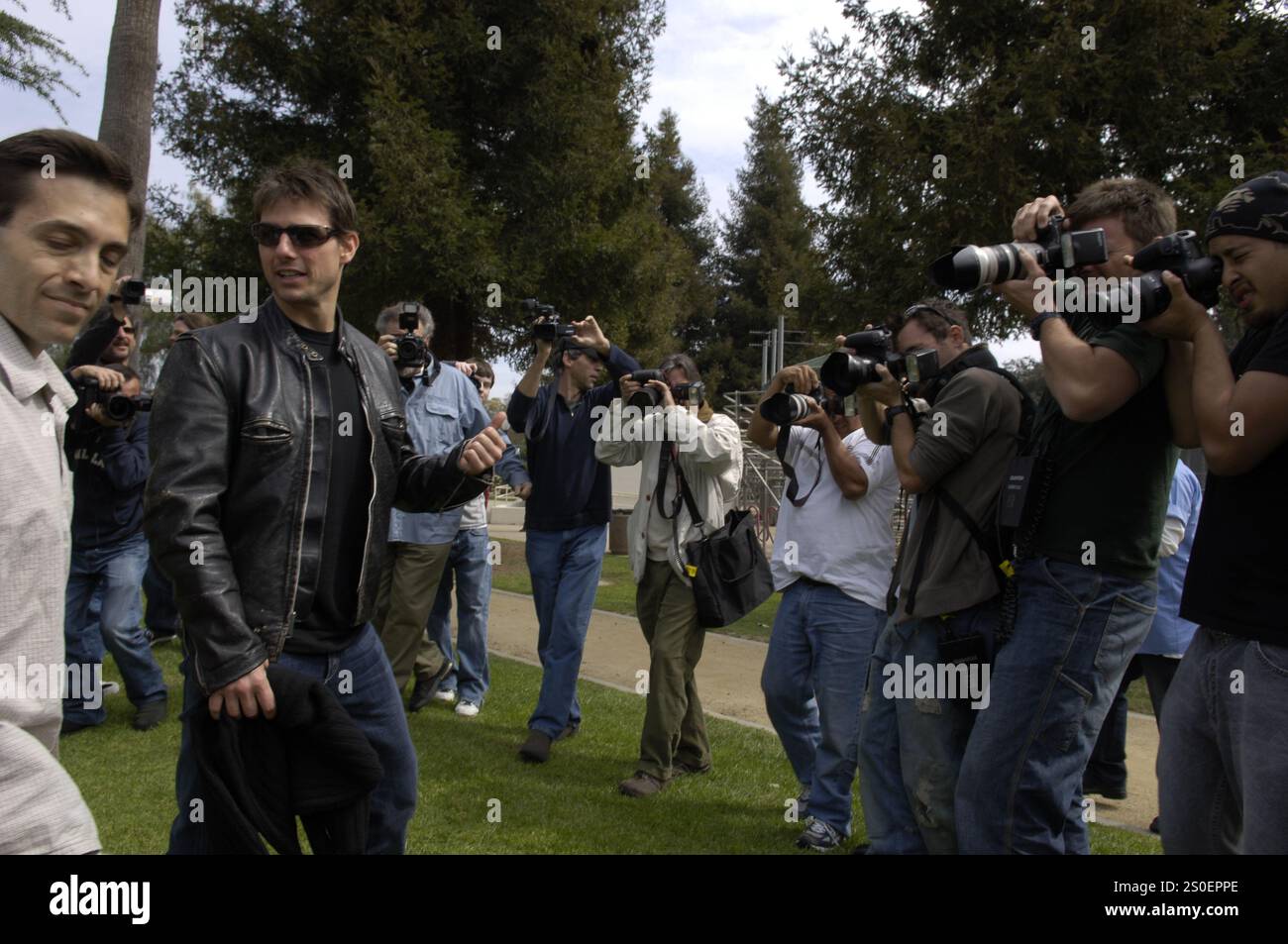 Tom Cruise attends a public event, sporting a black leather jacket and ...