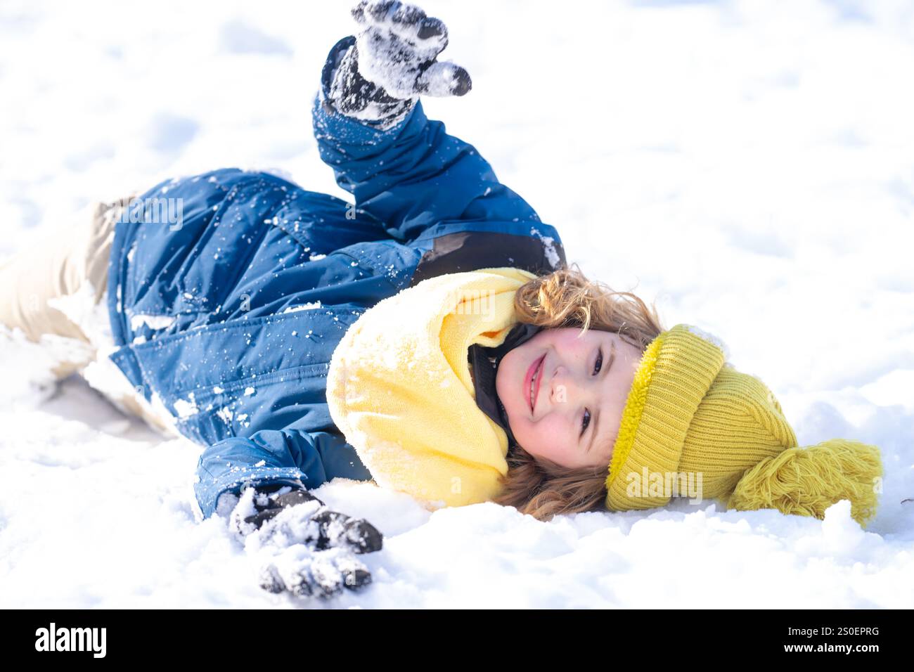 Child playing with snow, outdoors during snowfall. Winter child ...