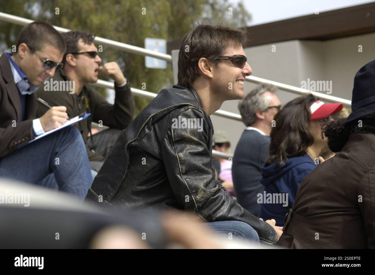 Tom Cruise attends a public event, sporting a black leather jacket and ...