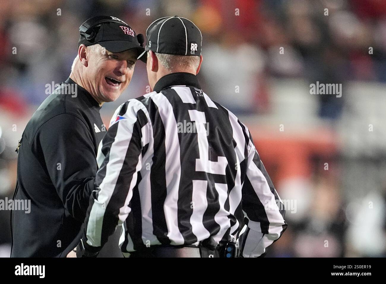 Texas Tech head coach Joey McGuire talks to an official during the ...