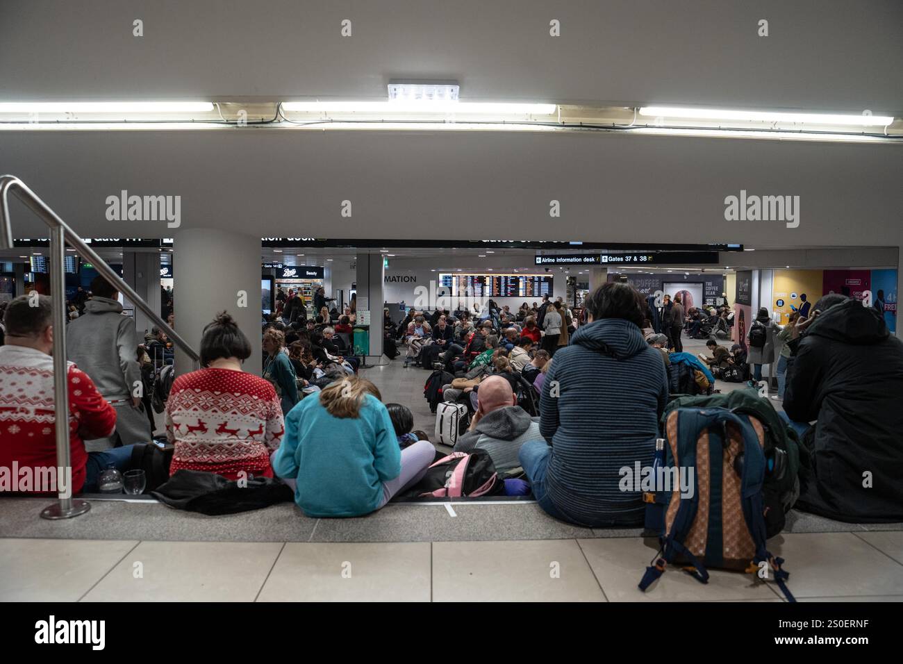 Passengers in the Manchester Airports are waiting for their flights in Terminal 3. Fog causes ...