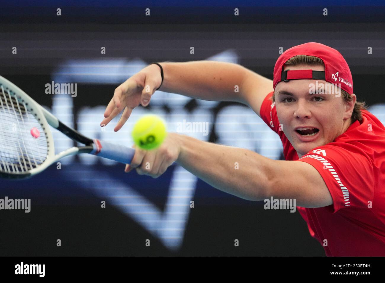 Switzerland's Dominic Stricker plays a backhand return to France's Ugo ...