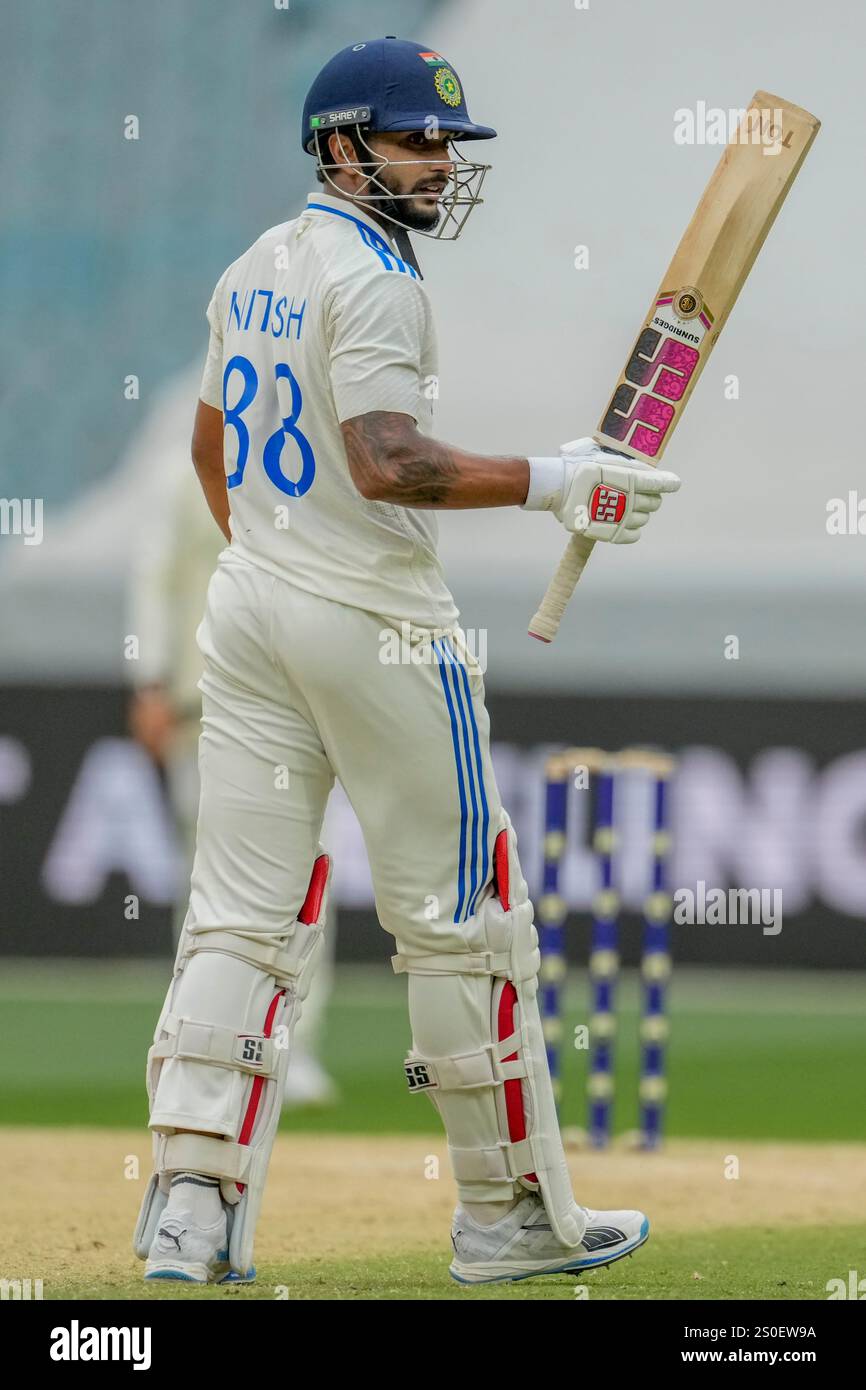 India's Nitish Kumar Reddy celebrates his fifty runs during play on the ...