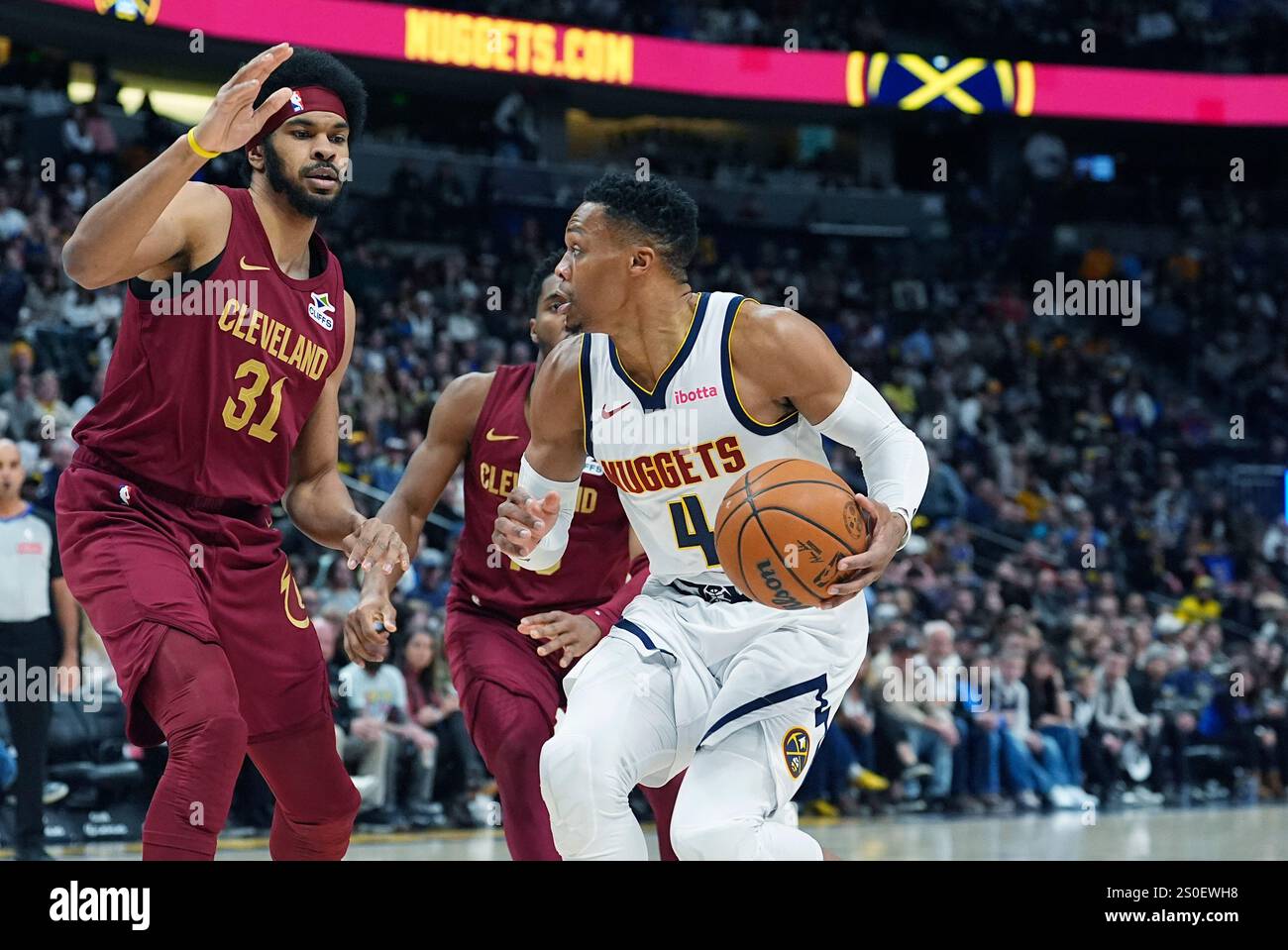 Denver Nuggets guard Russell Westbrook, right, drives to the basket as ...