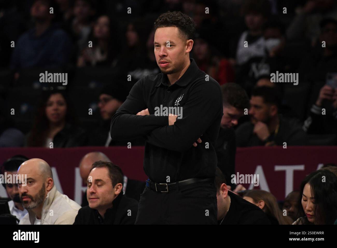 San Antonio Spurs' acting head coach Mitch Johnson stands on the court ...