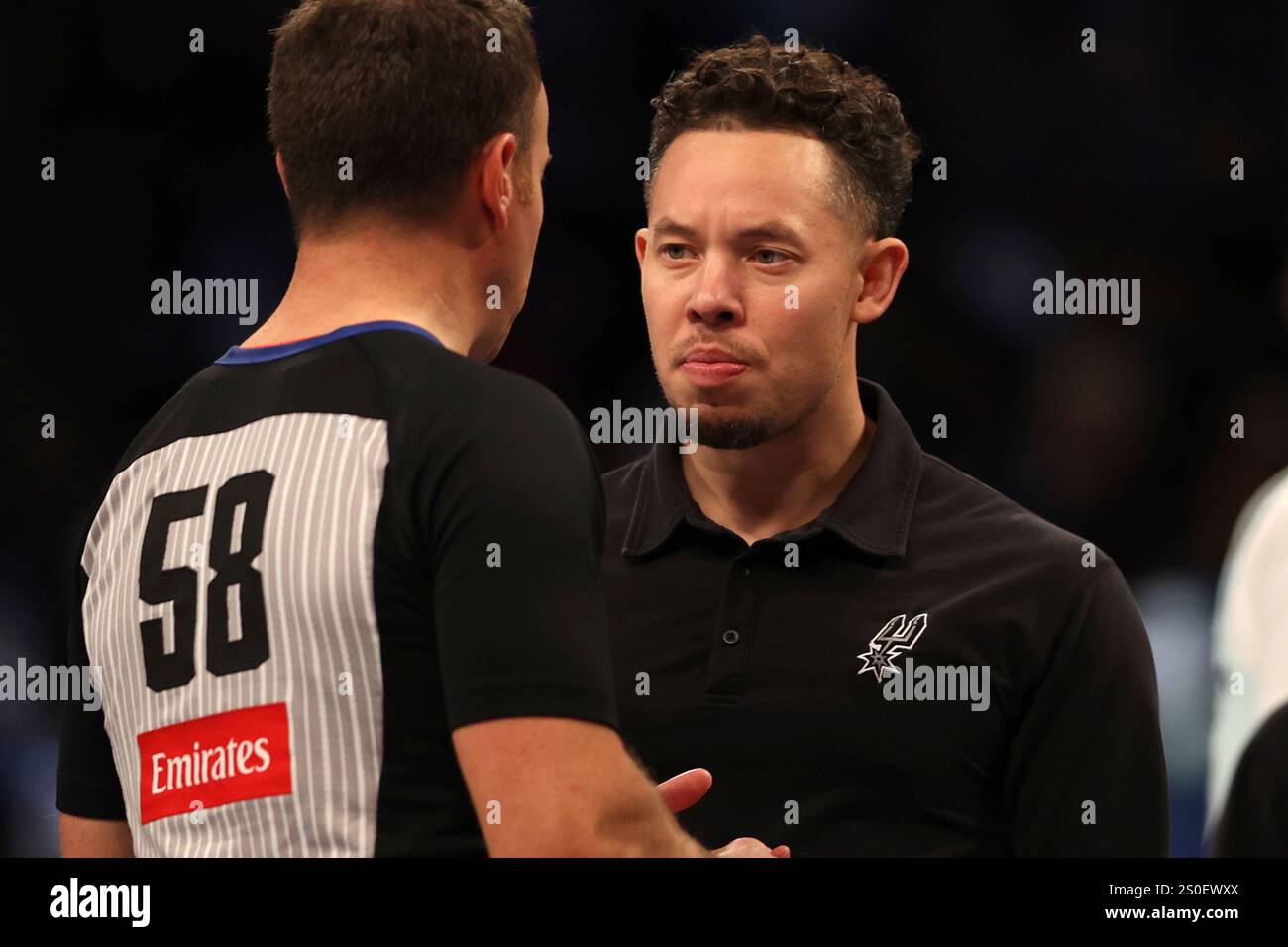 San Antonio Spurs' acting head coach Mitch Johnson, right, speaks to a ...