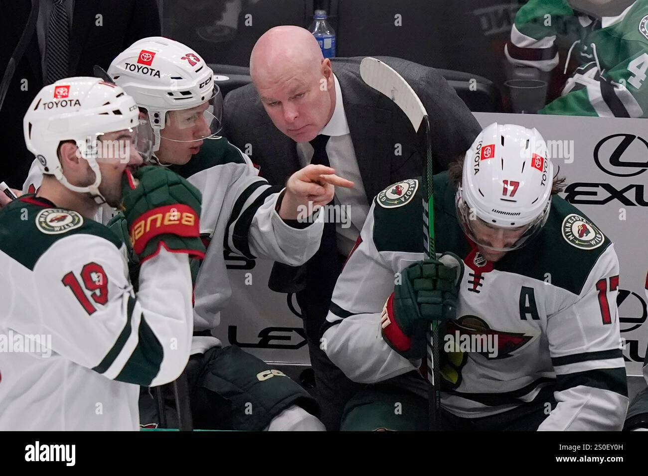 Minnesota Wild head coach John Hynes, center, listens to center Marco ...