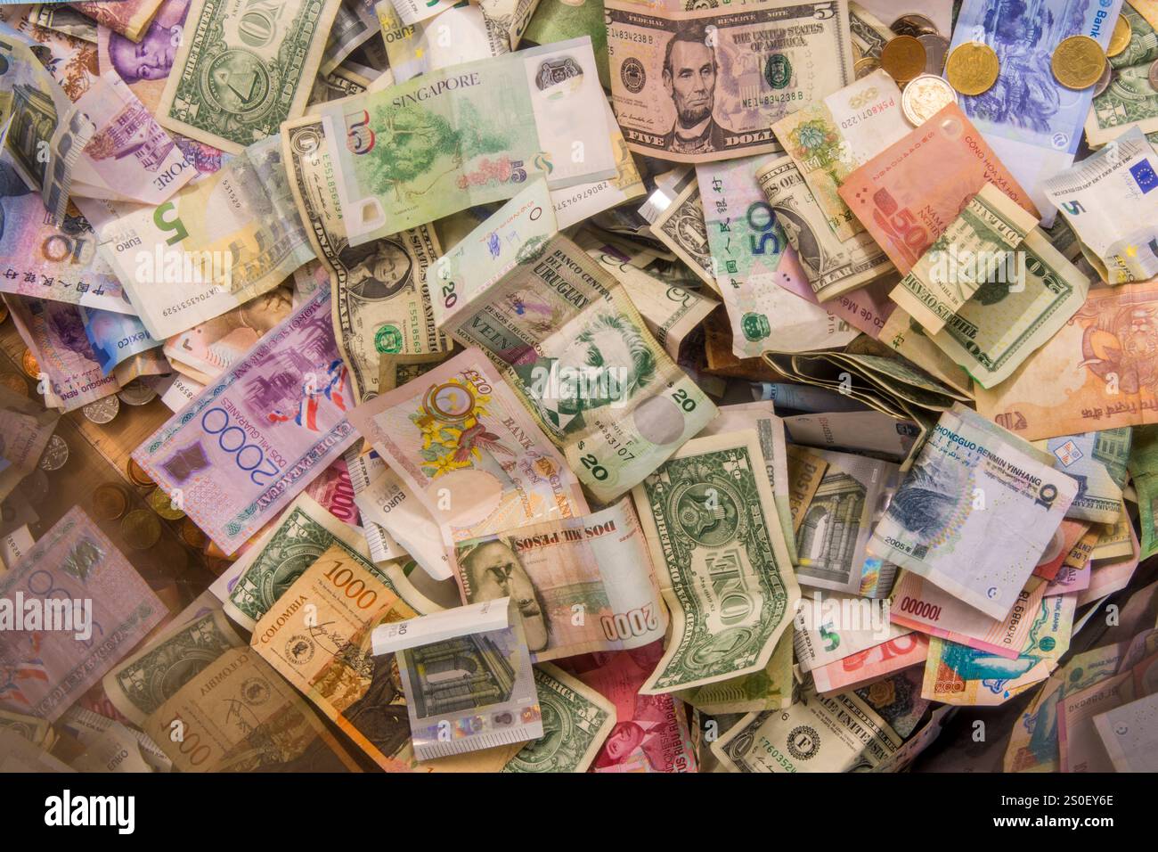 International foreign currency bills and coins in the donations box at ...