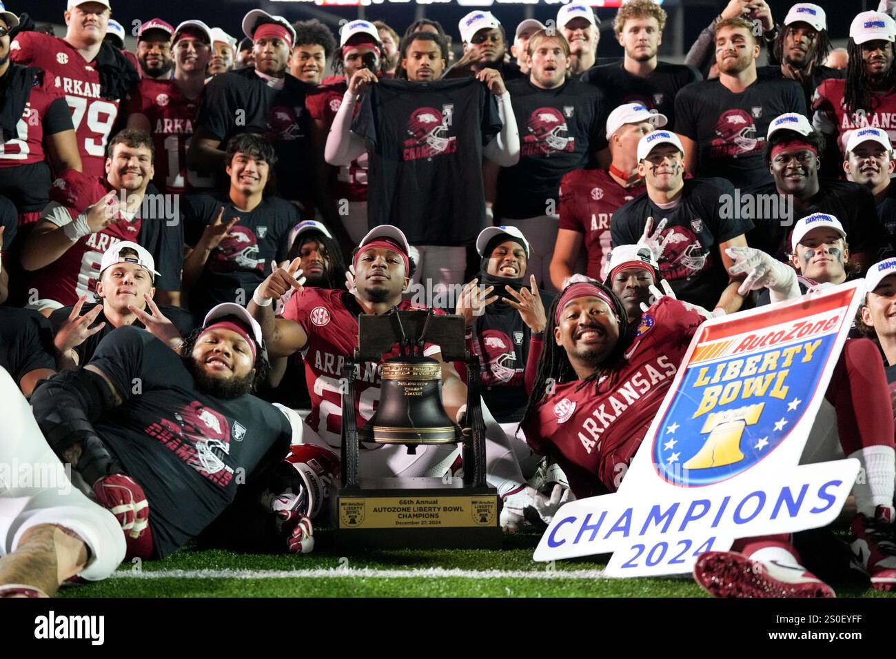 Arkansas players pose with the trophy after winning the Liberty Bowl ...