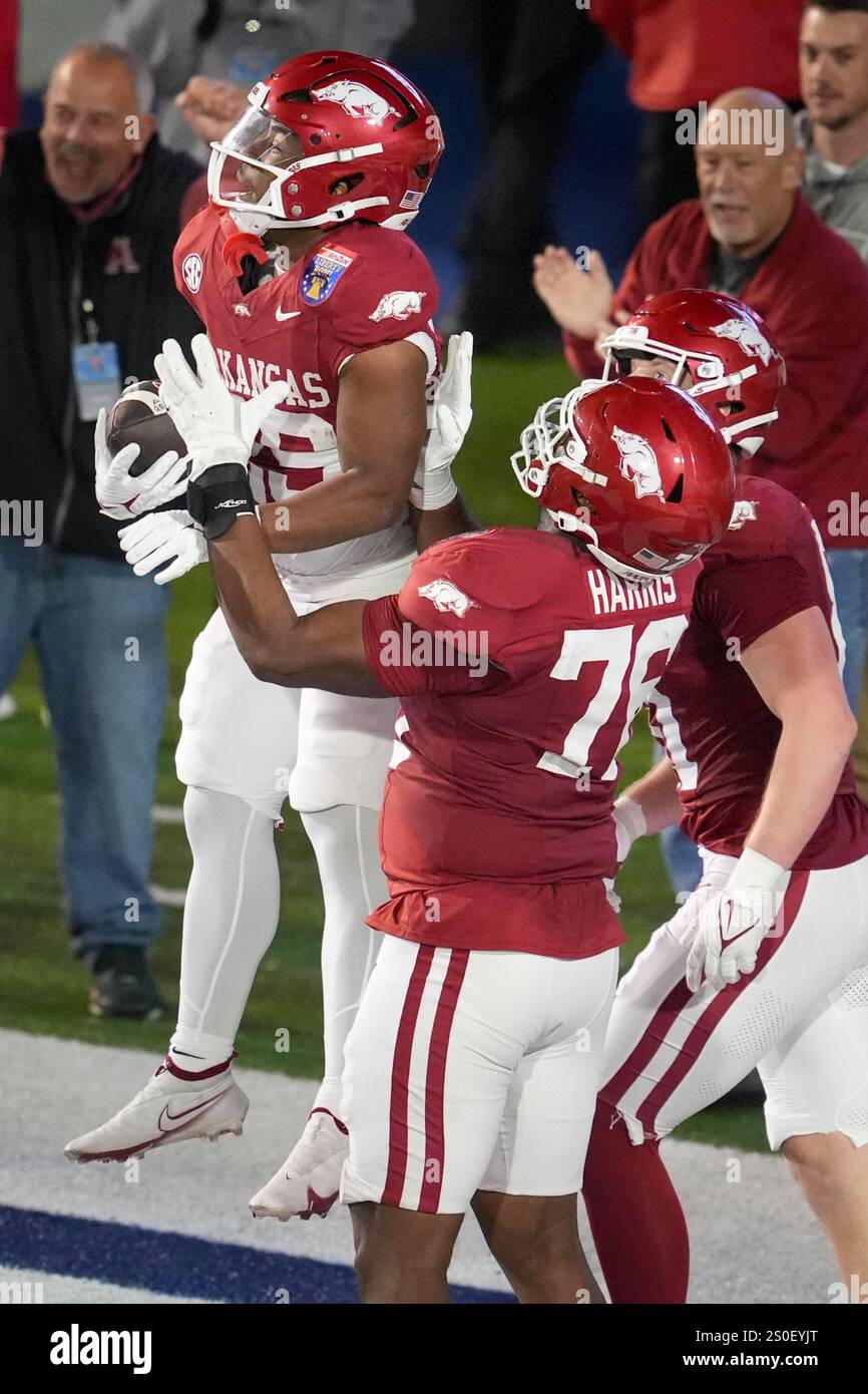 Arkansas running back Tyrell Reed Jr., left, celebrates his touchdown ...