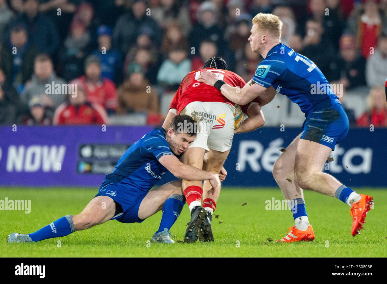 Limerick, Ireland. 28th Dec, 2024. Mike Haley of Munster tackled by ...