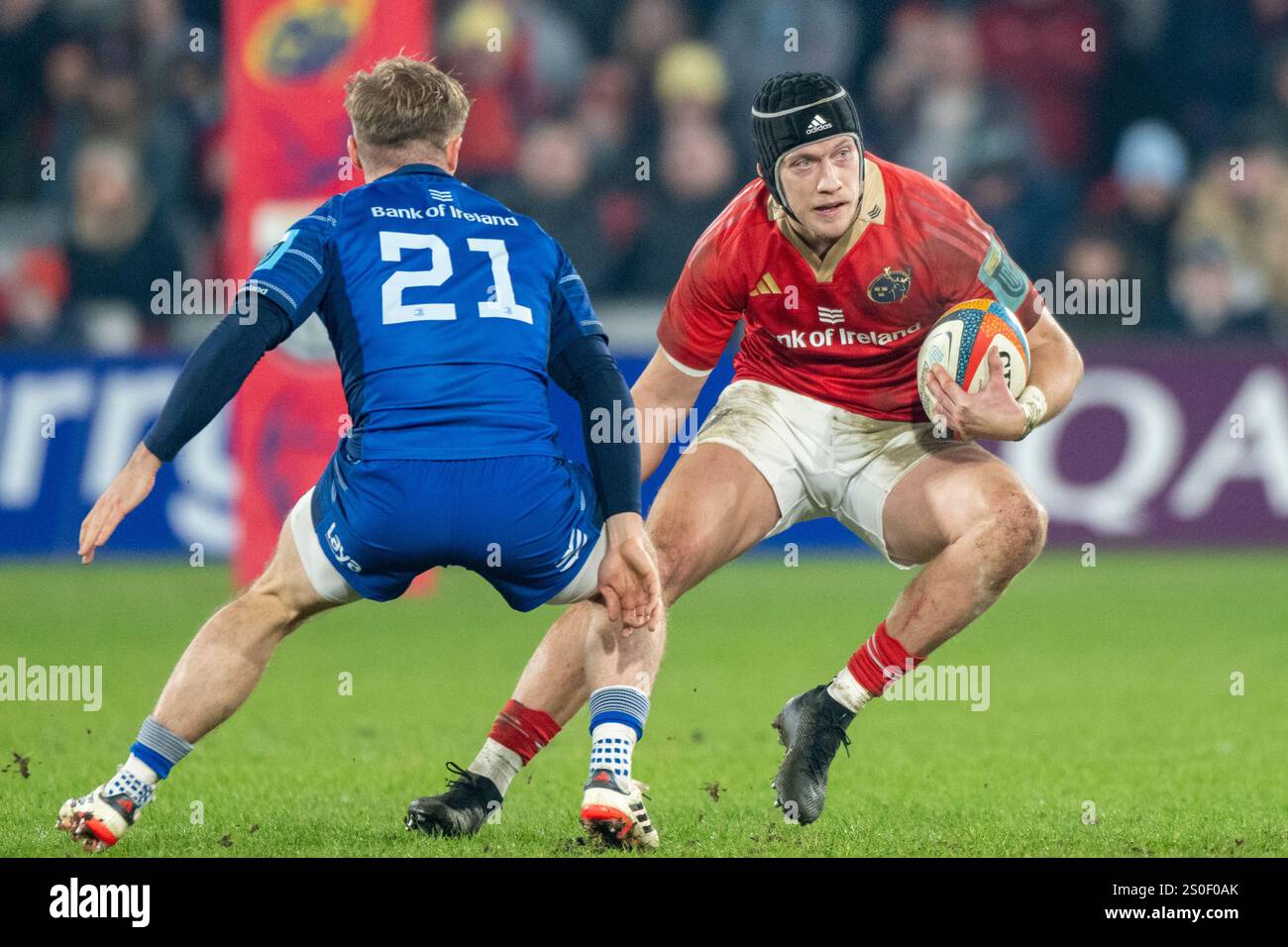 Mike Haley of Munster with the ball and Fintan Gunne of Leinster during ...