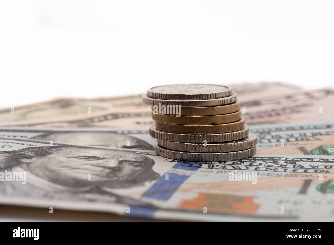 A stack of coins and a bill with the words United States of America on ...