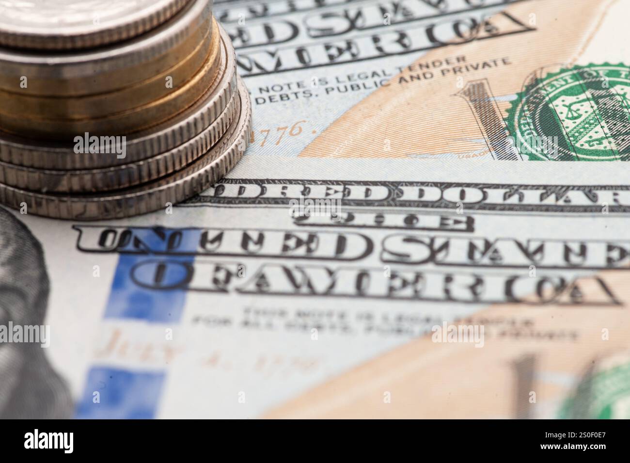 A stack of coins and a bill with the words United States of America on ...