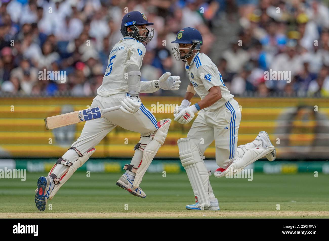 India's Washington Sundar, left, and Nitish Kumar Reddy run between the ...