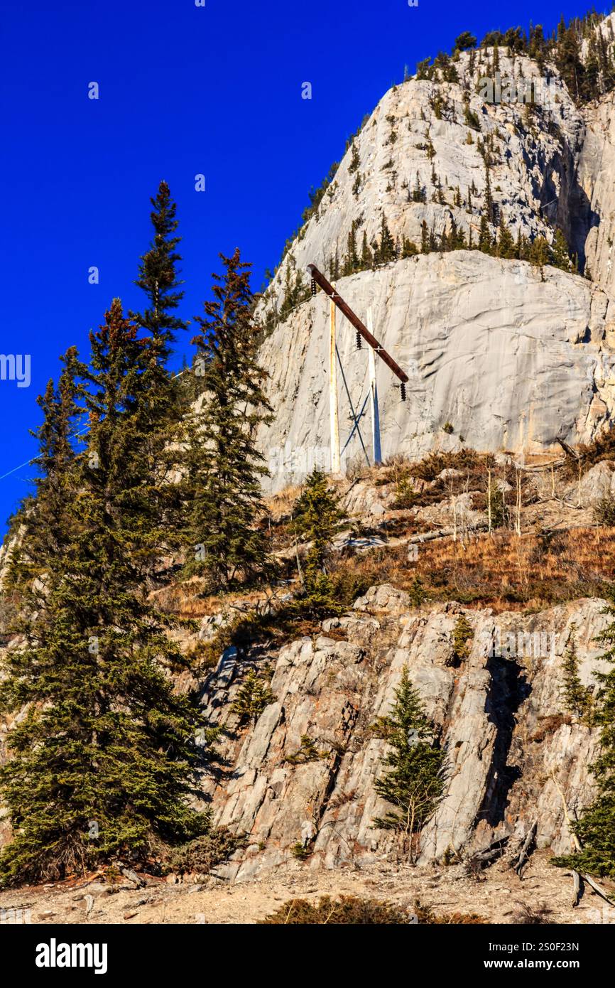 A mountain with a tree on it and a wire hanging from it. The wire is ...