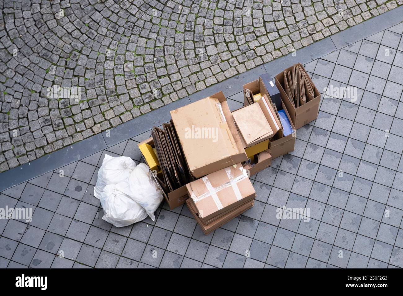 Garbage in white plastic bag and empty cardboard boxes, partially ...