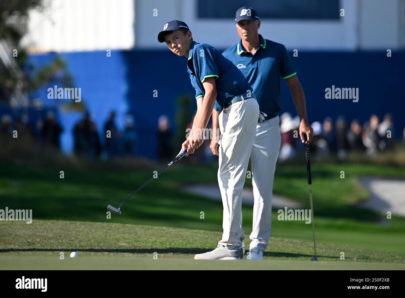 Matt Kuchar, right, watches his son Carson Kuchar putt on the 18th ...
