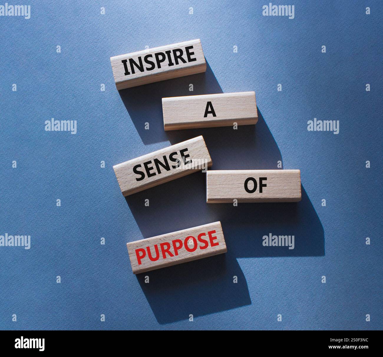 Purpose symbol. Wooden blocks with words Inspire a sense of Purpose ...