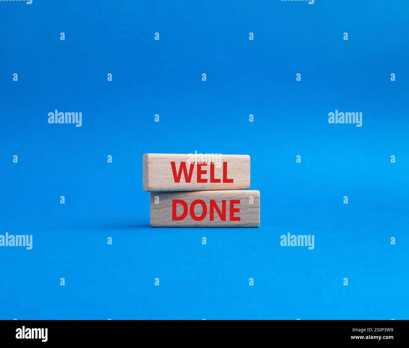 Well done symbol. Wooden blocks with words Well done. Beautiful blue ...