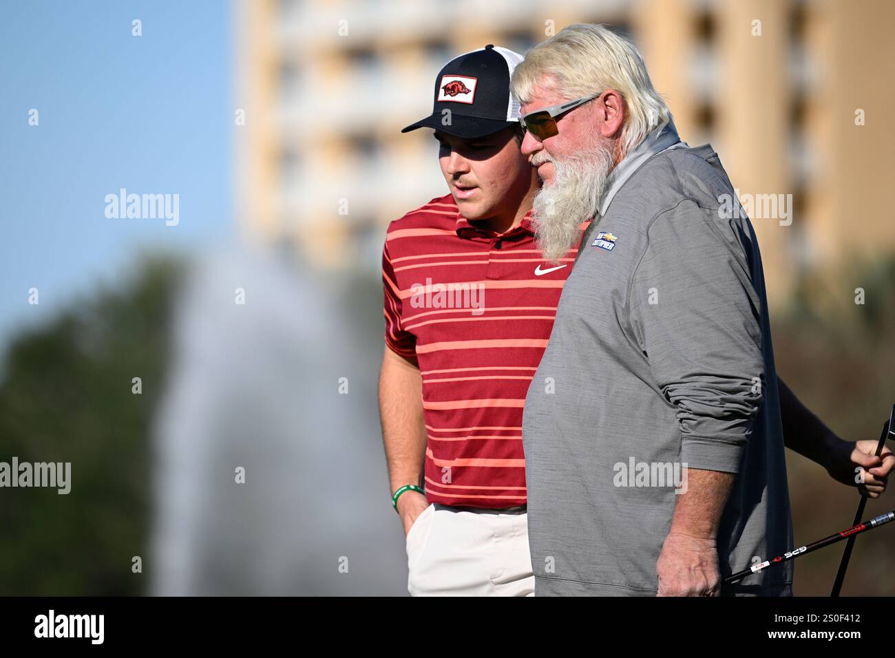 John Daly, right, and his son John Daly II hug after finishing on the ...