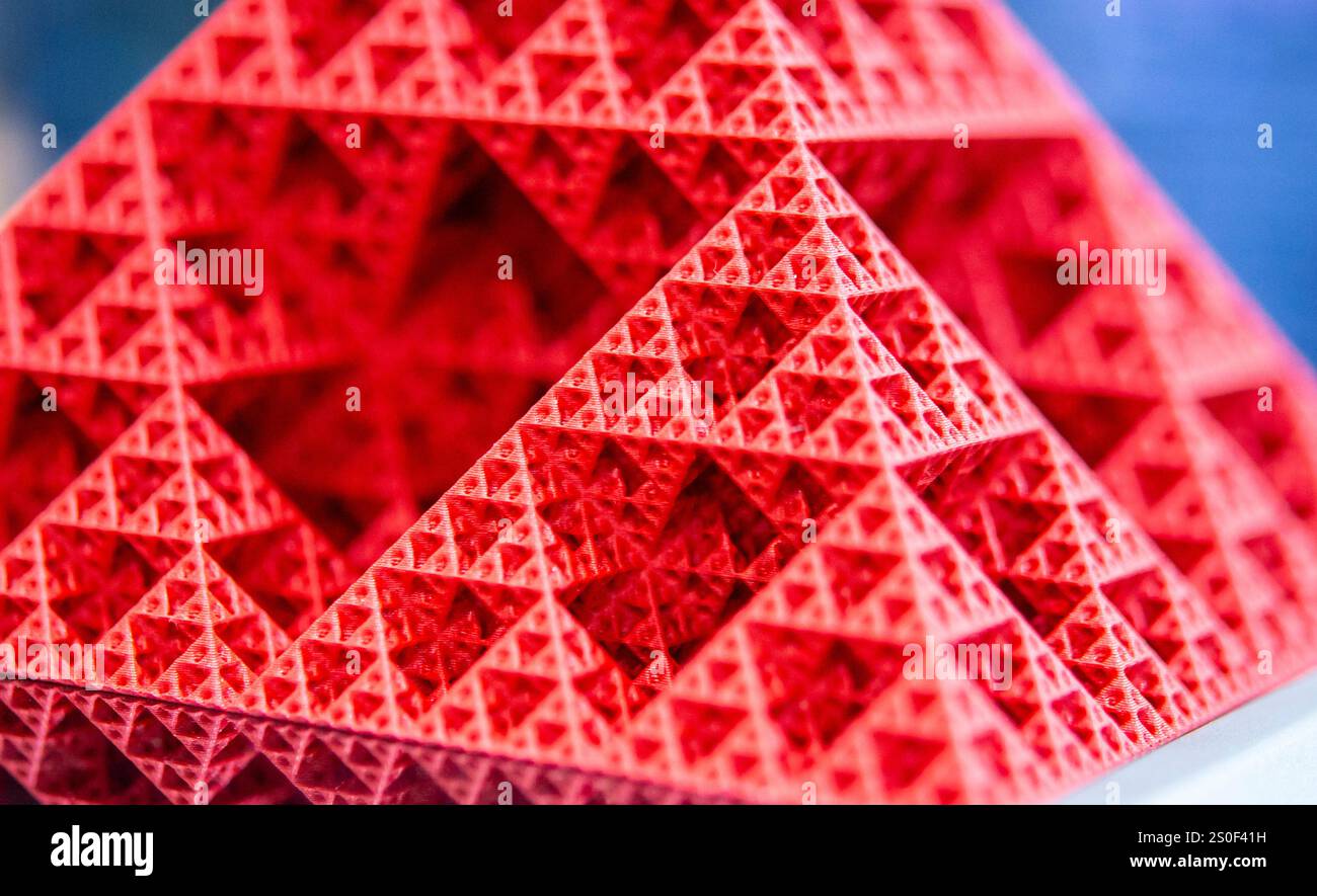 Art object printed on 3D printer from red melted plastic close-up ...