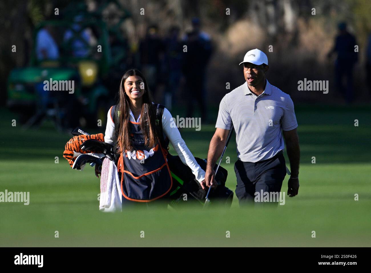 Tiger Woods, right, and his daughter Sam Woods walk to the 18th green ...