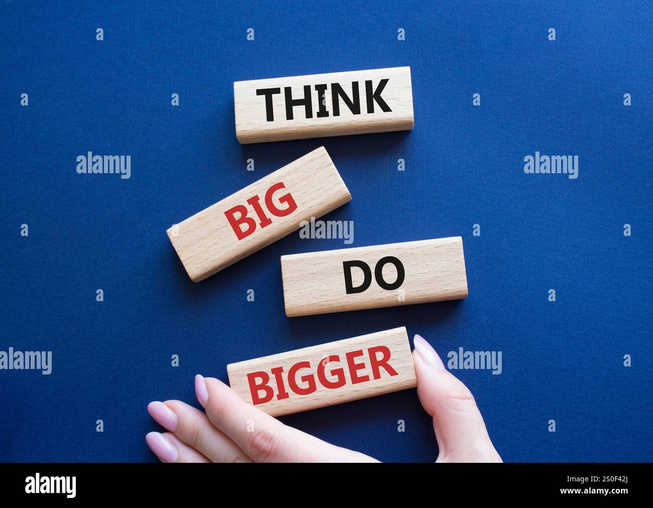 Think Big Do Bigger symbol. Wooden blocks with words Think Big Do ...