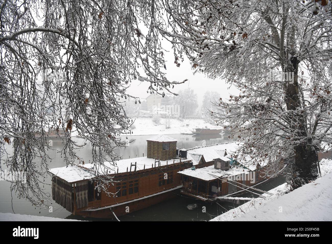 Srinagar, Jammu And Kashmir, India. 28th Dec, 2024. Houseboats covered ...