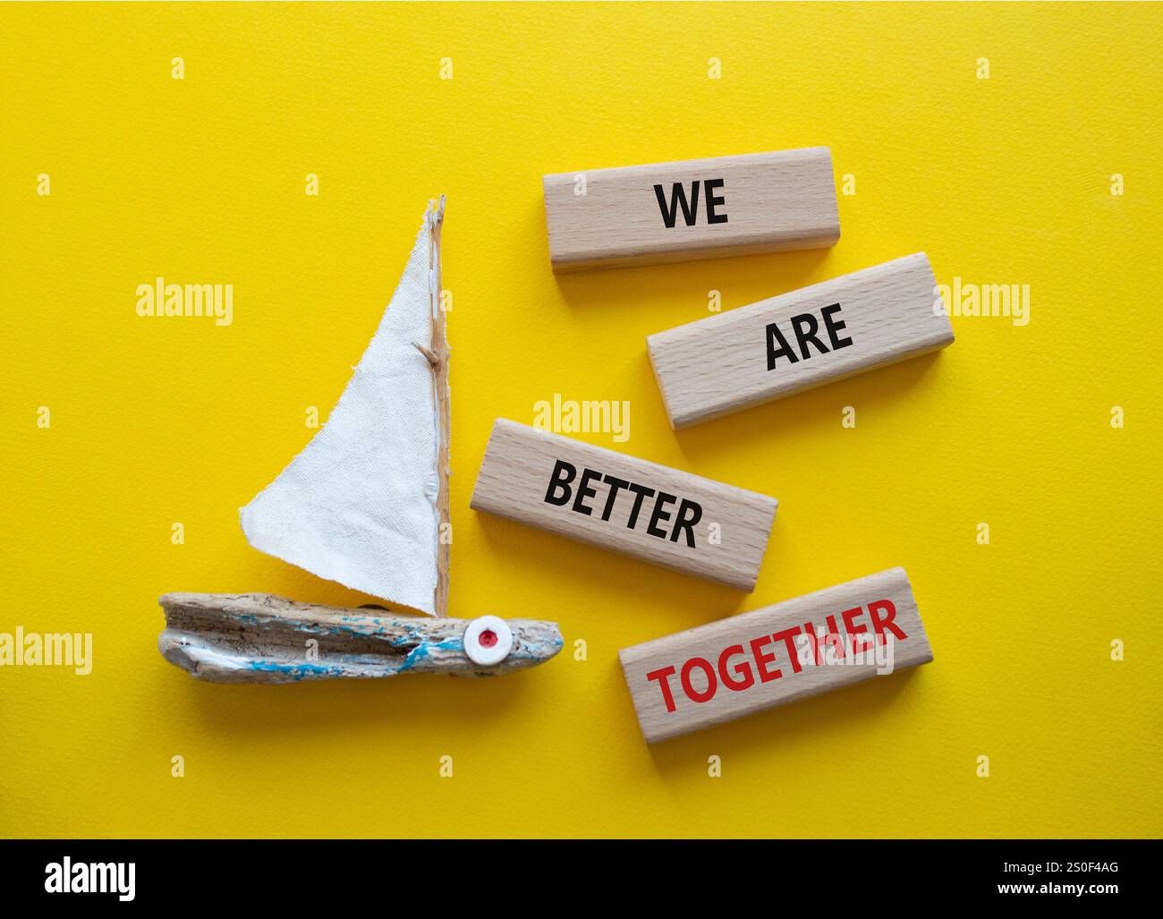 We are better together symbol. Wooden blocks with words We are better together. Beautiful yellow ...
