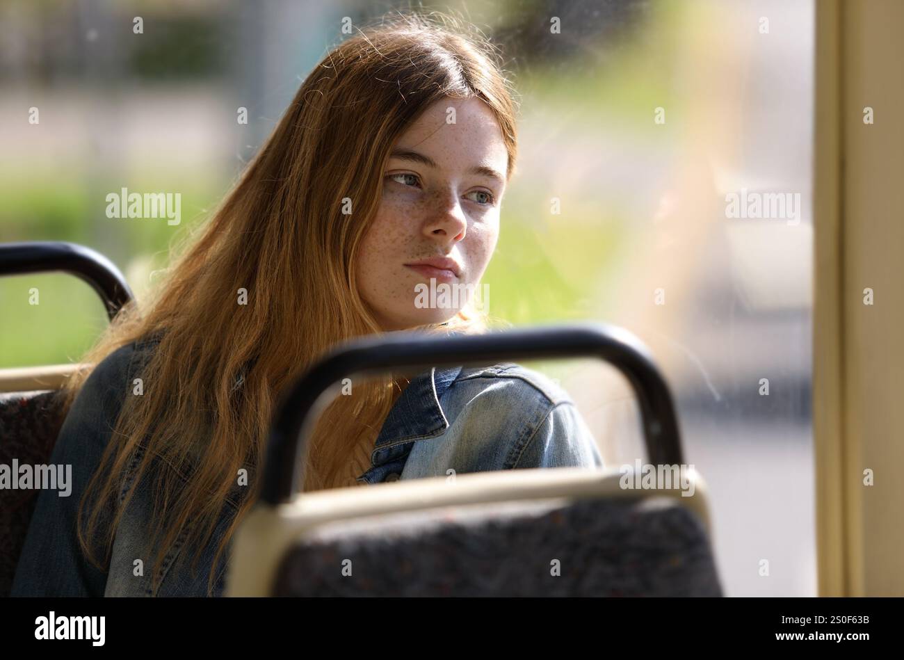 Young lovely girl passenger enjoying trip at public transport in modern ...