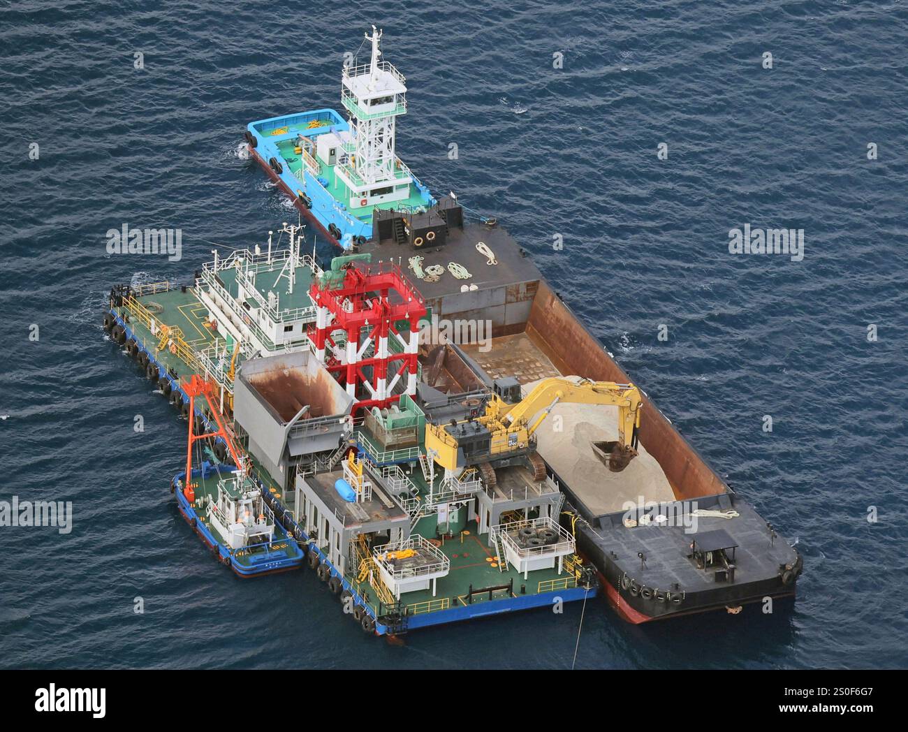 An aerial photo shows the work to improve the soft ground at Oura Bay ...