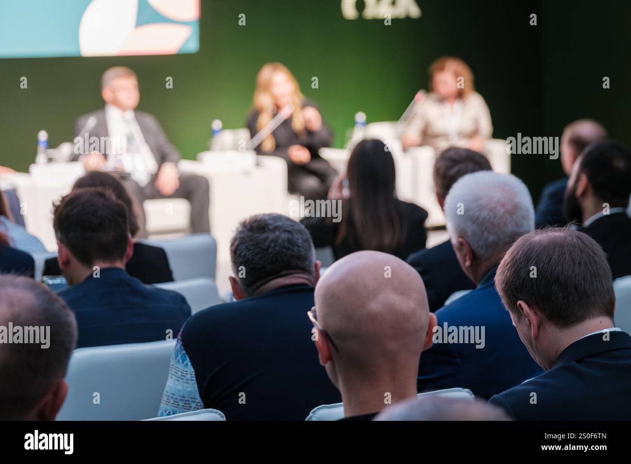 Large group of professionals attending a business symposium, focusing ...