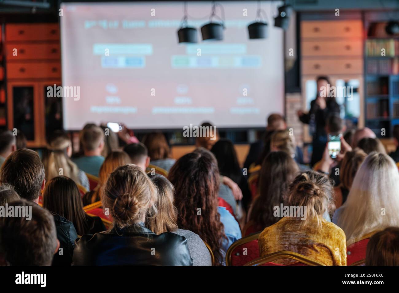 Large crowd attending a speaker presentation in a conference room with ...