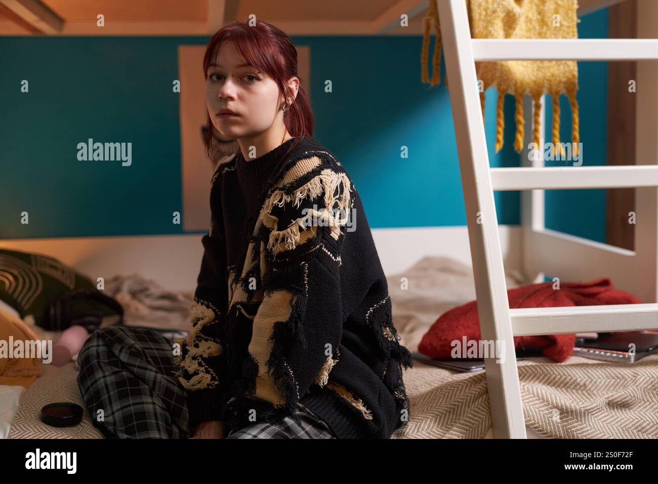 Gen Z Girl Sitting on Bed in Dorm Room Stock Photo - Alamy