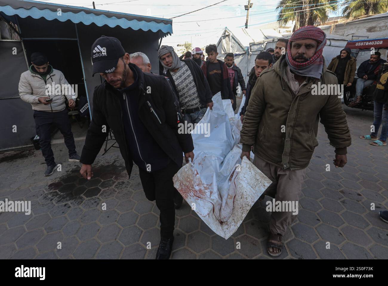 Relatives of the Palestinians died in Israeli attacks, mourn as they ...